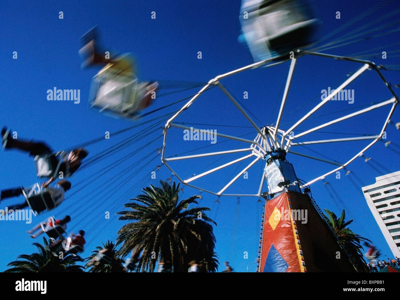 People On A Flying Swings Ride At A Funfair, Blurred Motion Stock Photo ...