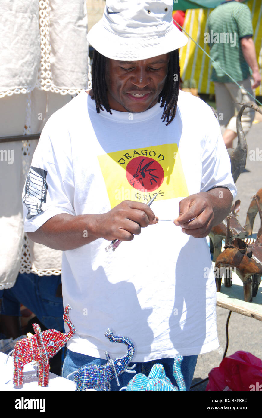 African artist/craftsman sells his goods at Green Point Market, Cape ...