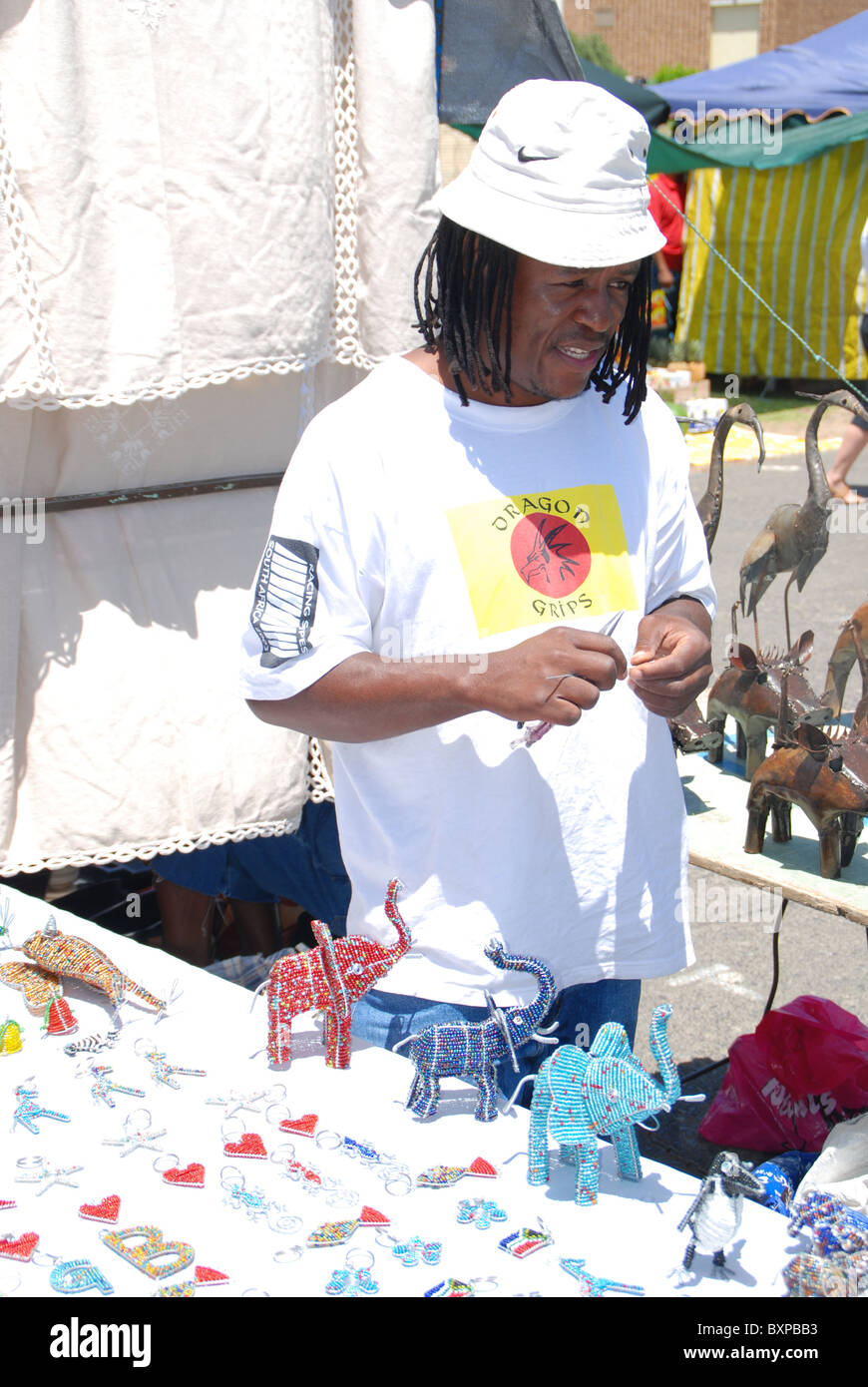 African artist/craftsman sells his goods at Green Point Market, Cape ...