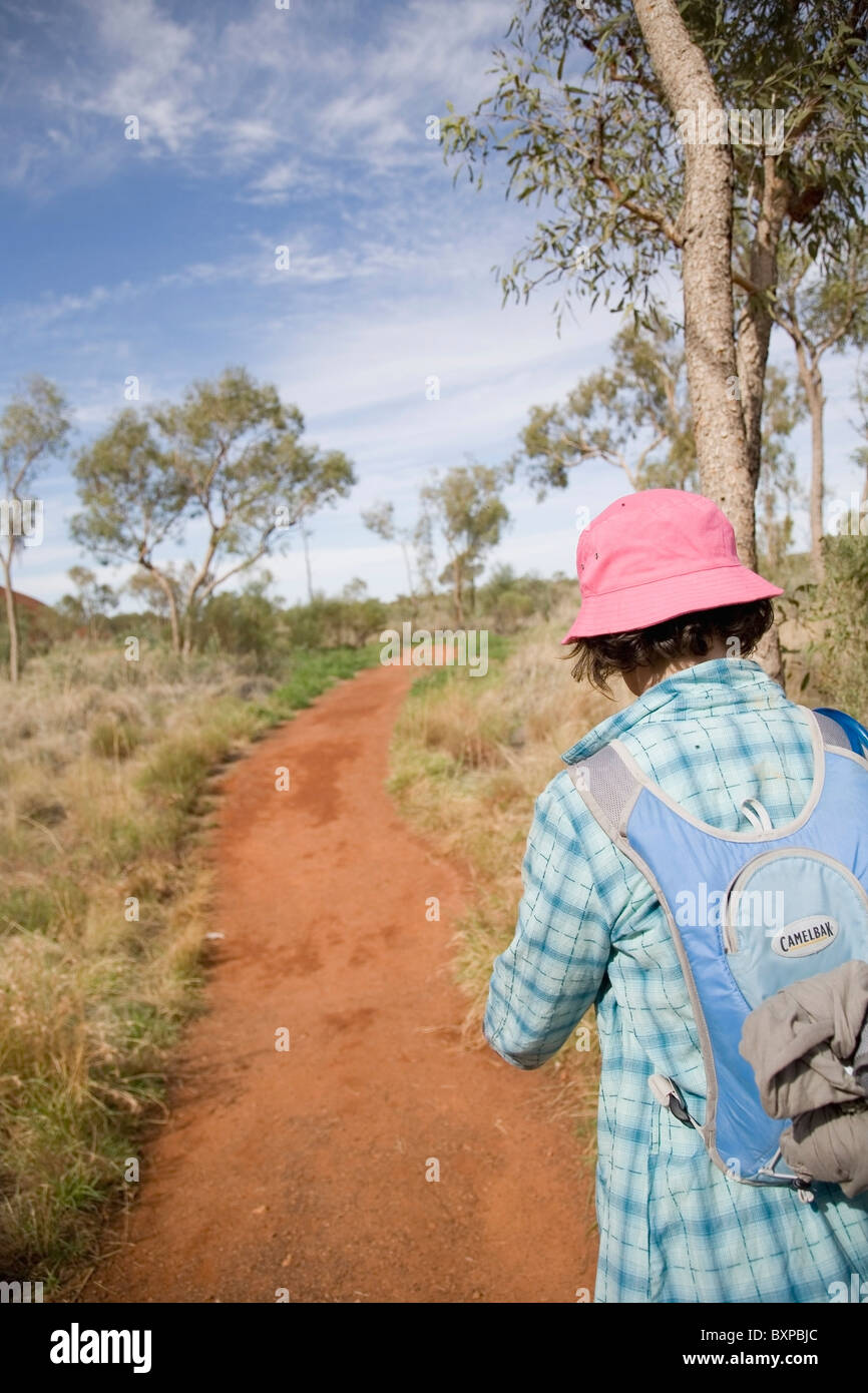 Woman Walking Down Path In Kata Tjuta Park Stock Photo - Alamy