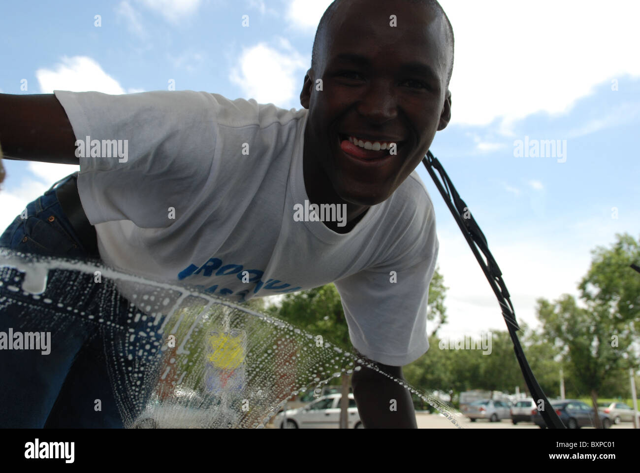 Man washing windscreen with a smile, South Africa Stock Photo - Alamy