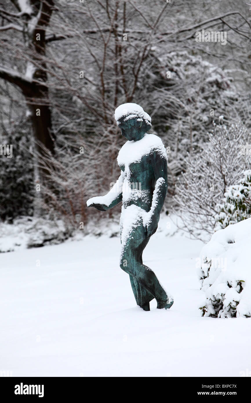 Winter in a park. Snow covered statues, monuments and artwork. Gruga ...