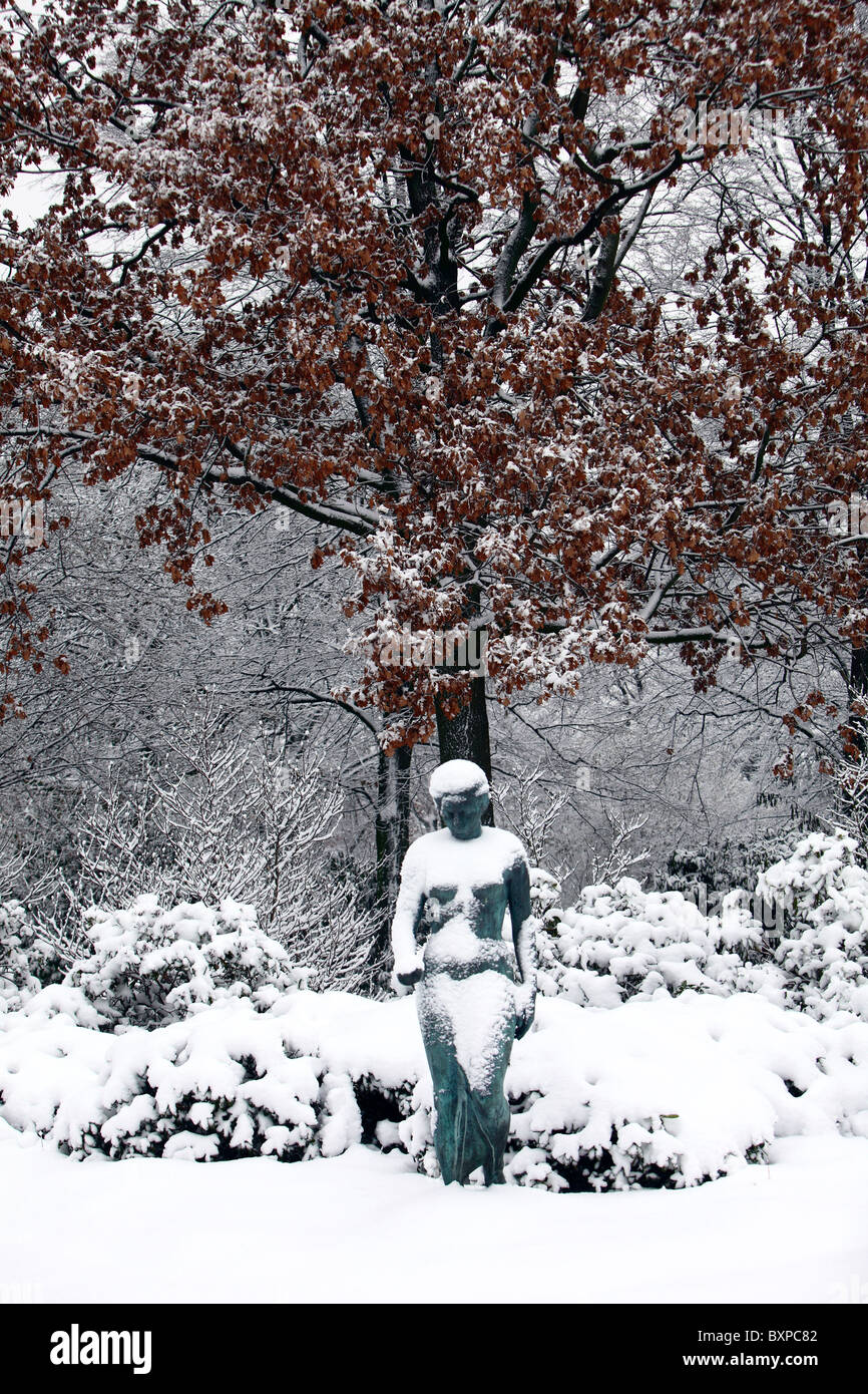 Winter in a park. Snow covered statues, monuments and artwork. Gruga ...