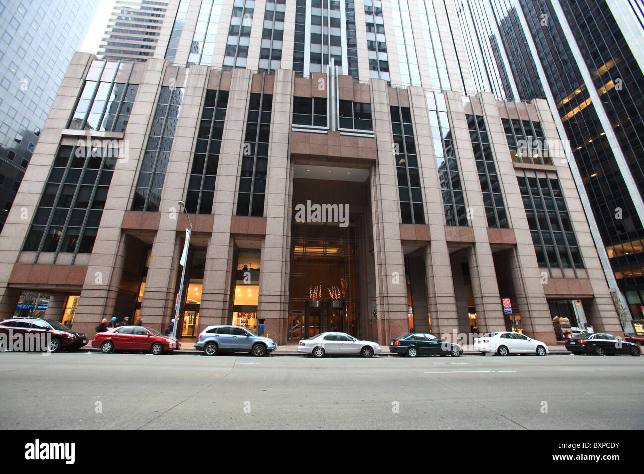 Vehicles parking in front of a high-rise building on Sixth avenue ...