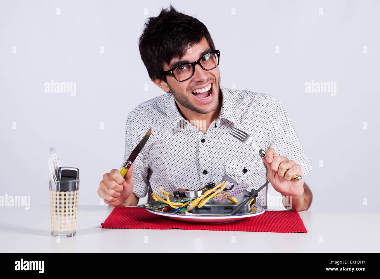 Crazy young man eating technology hi-res stock photography and images ...
