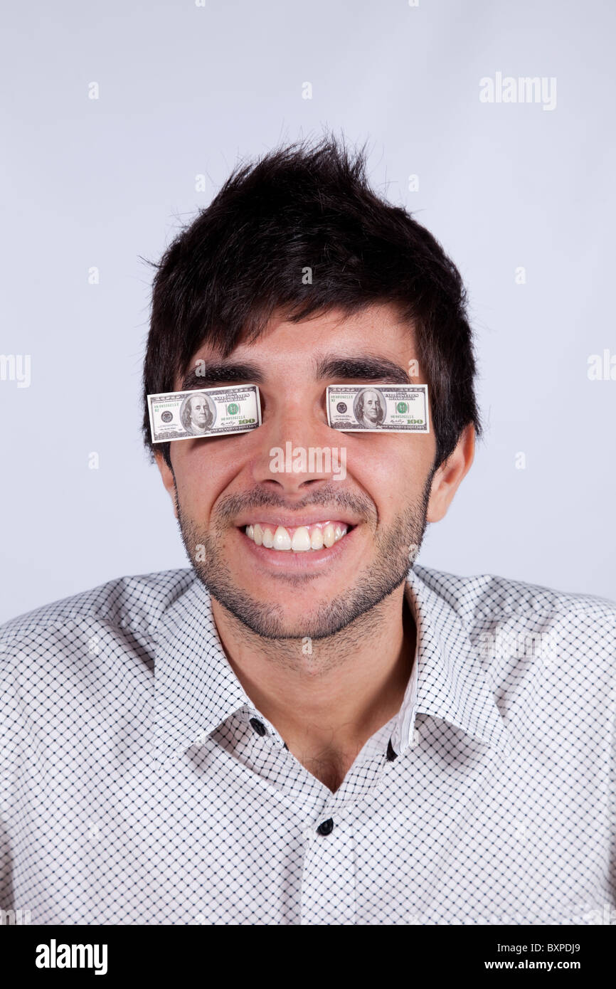 Young man with little dollar bills covering his eyes Stock Photo - Alamy