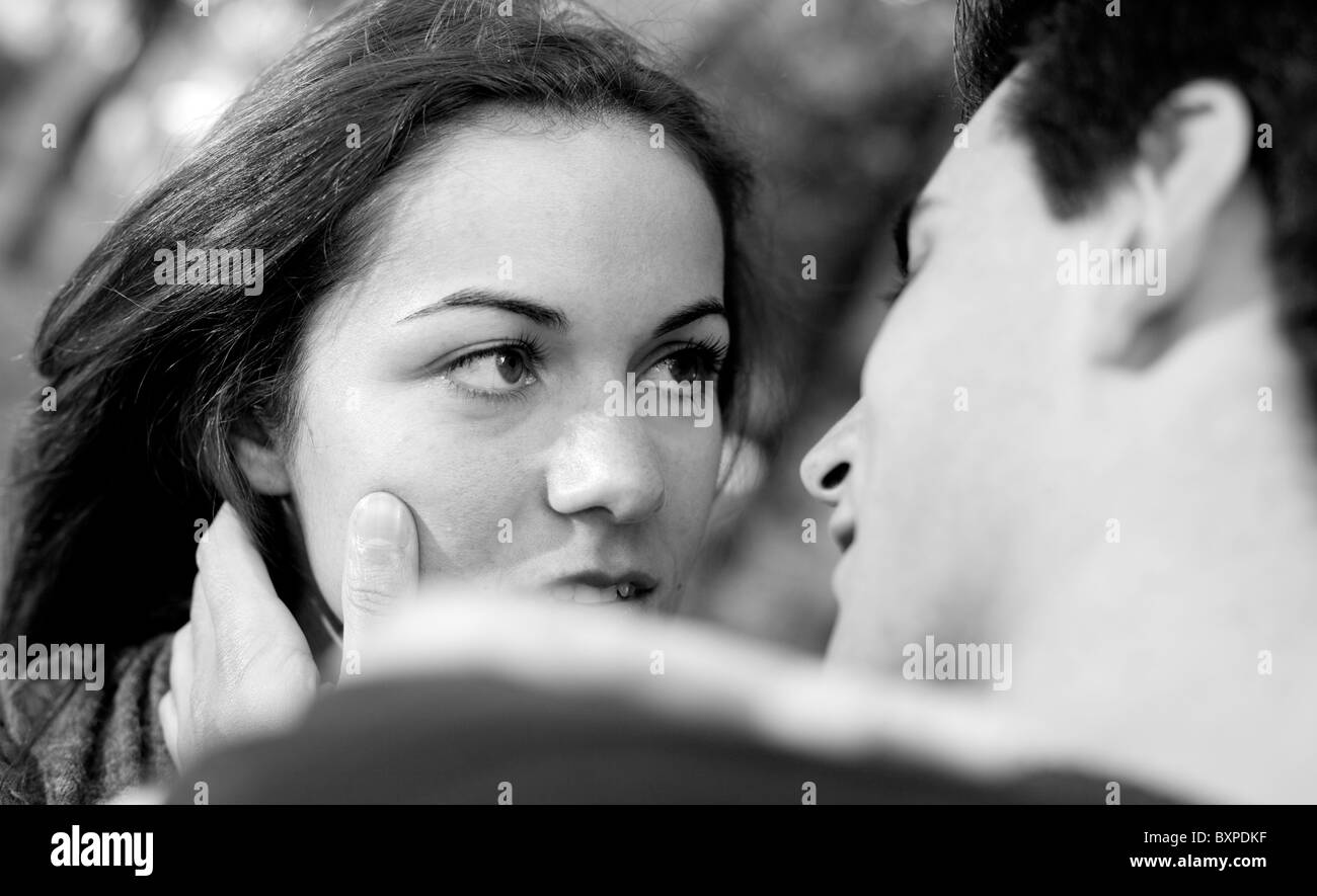 Love and affection between a young couple at the park in autumn season ...