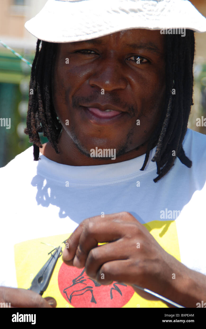 African artist/craftsman sells his goods at Green Point Market, Cape ...