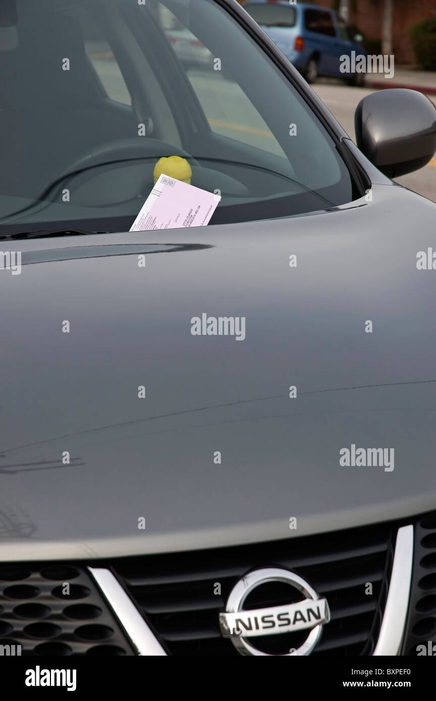 A car with a parking ticket issued due to an expired meter Stock Photo ...