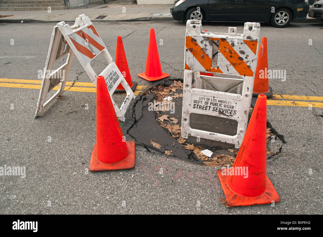 Large pothole on the street caused by heavy rain Stock Photo - Alamy