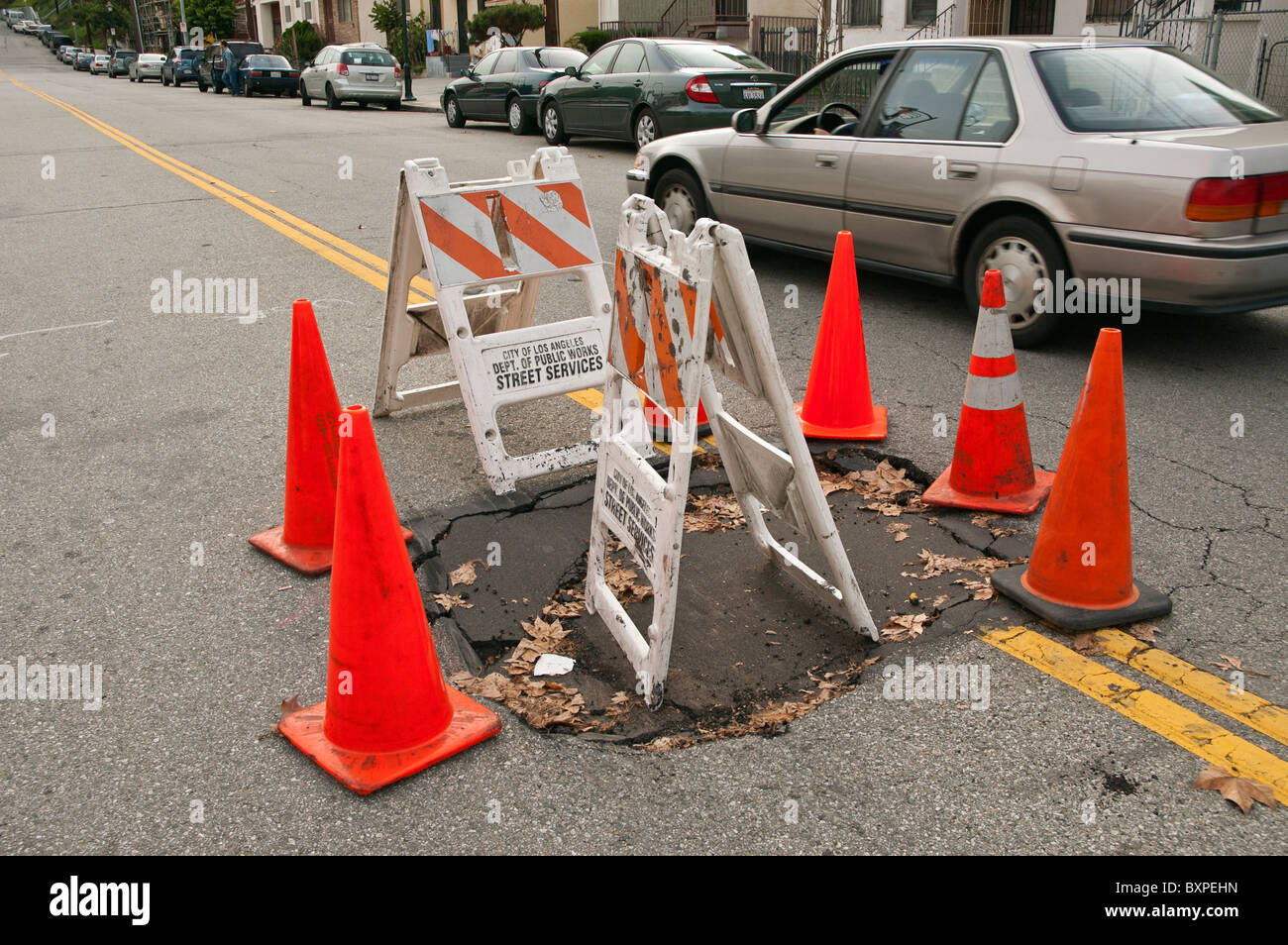 Large pothole on the street caused by heavy rain Stock Photo - Alamy