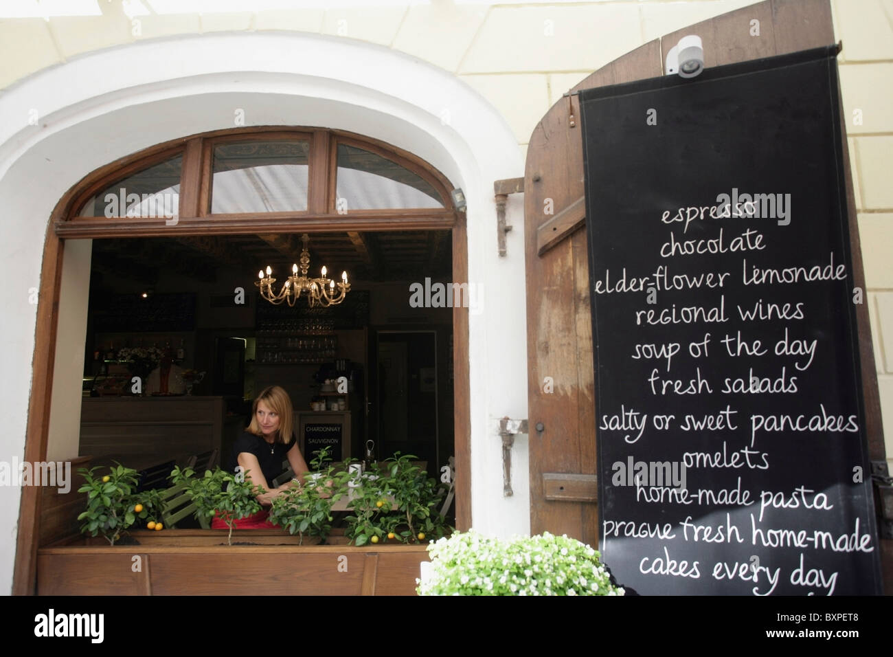 Woman Sitting In Window Of Cafe Stock Photo - Alamy
