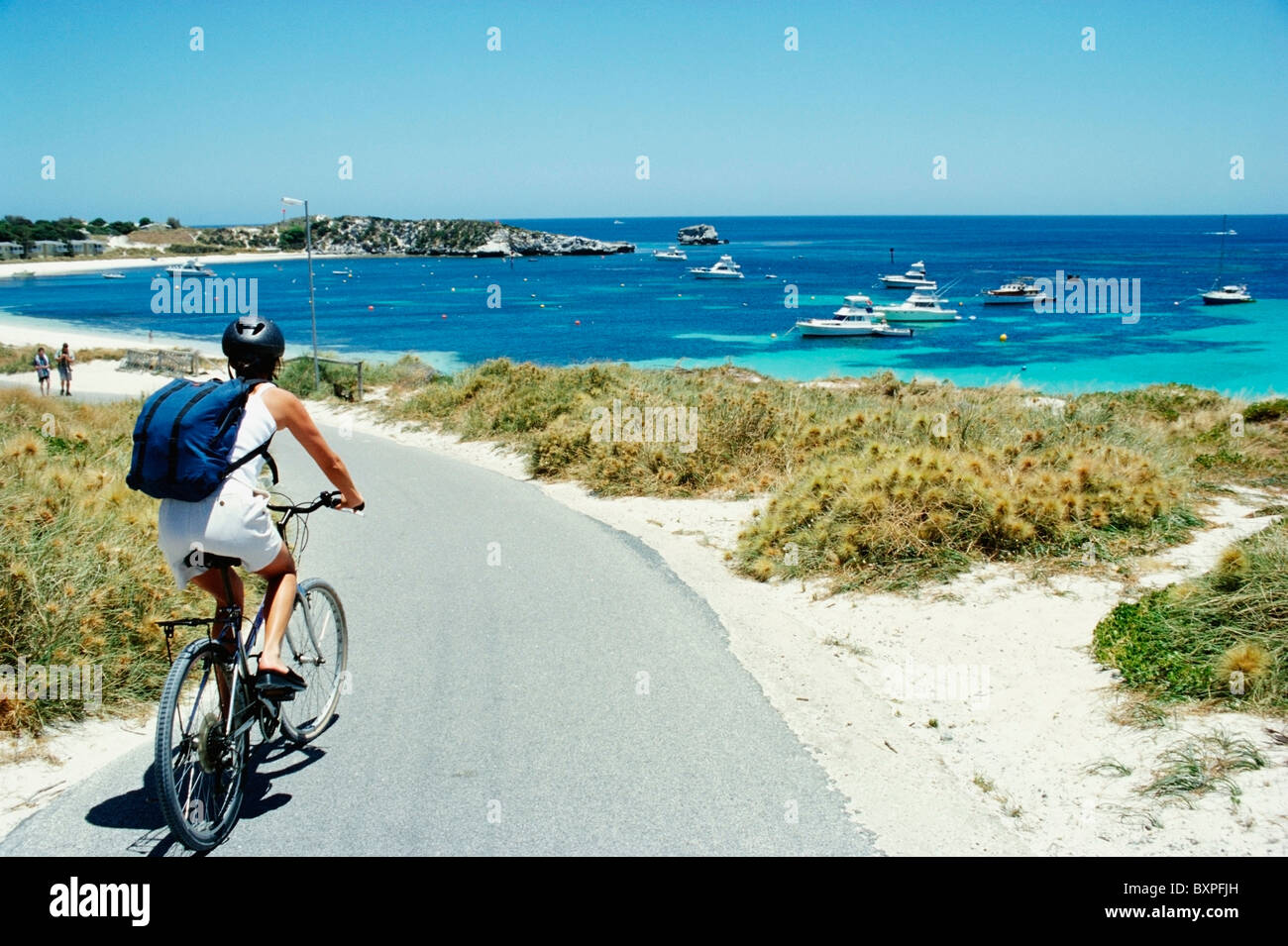 Female Tourist Cycling Along The Beach Stock Photo - Alamy