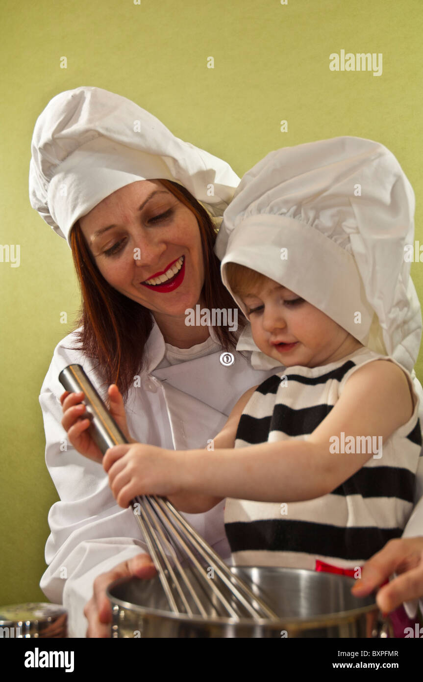 Mother and young daughter playing chef Stock Photo - Alamy