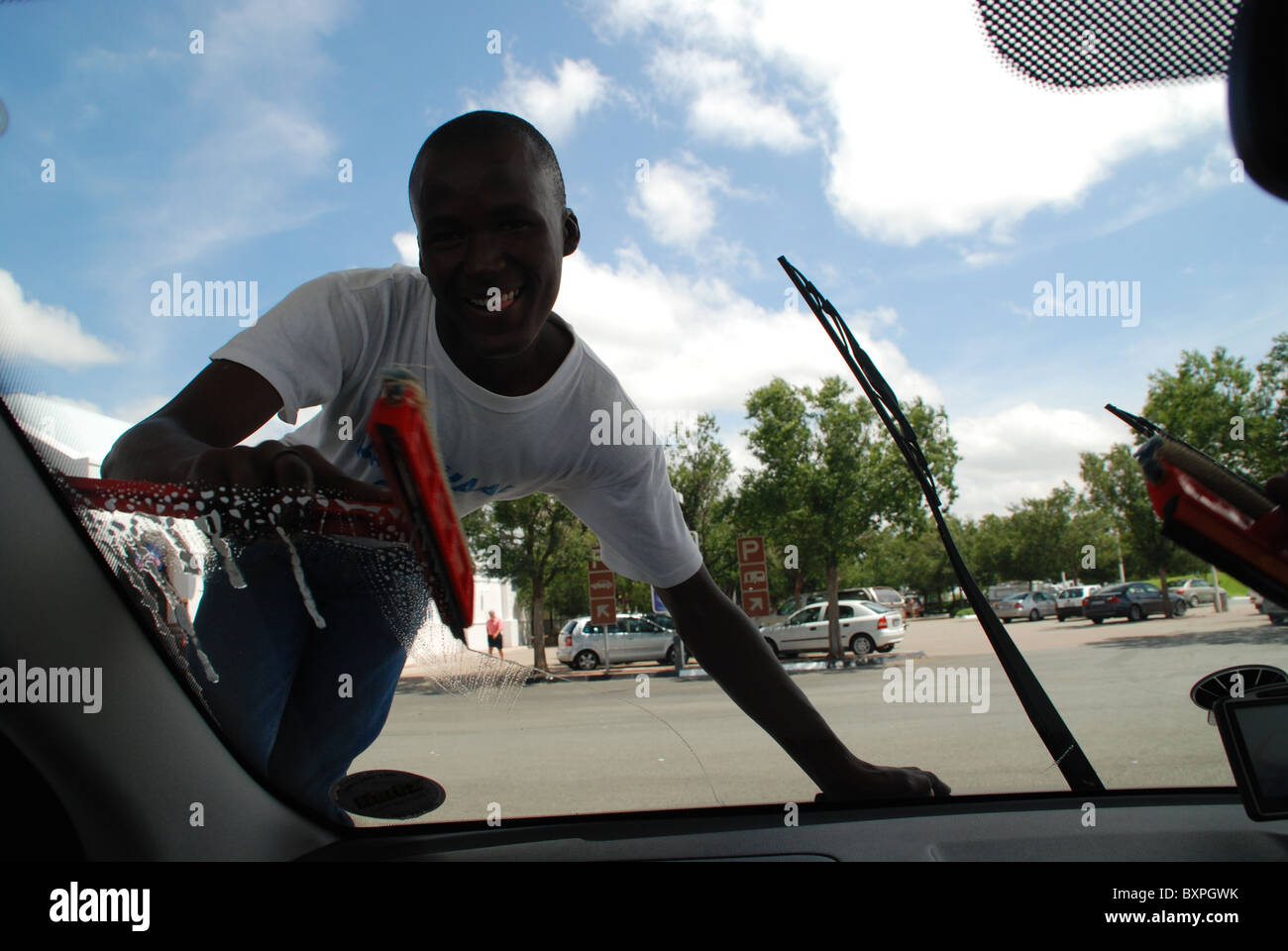 Man washing windscreen with a smile, South Africa Stock Photo - Alamy