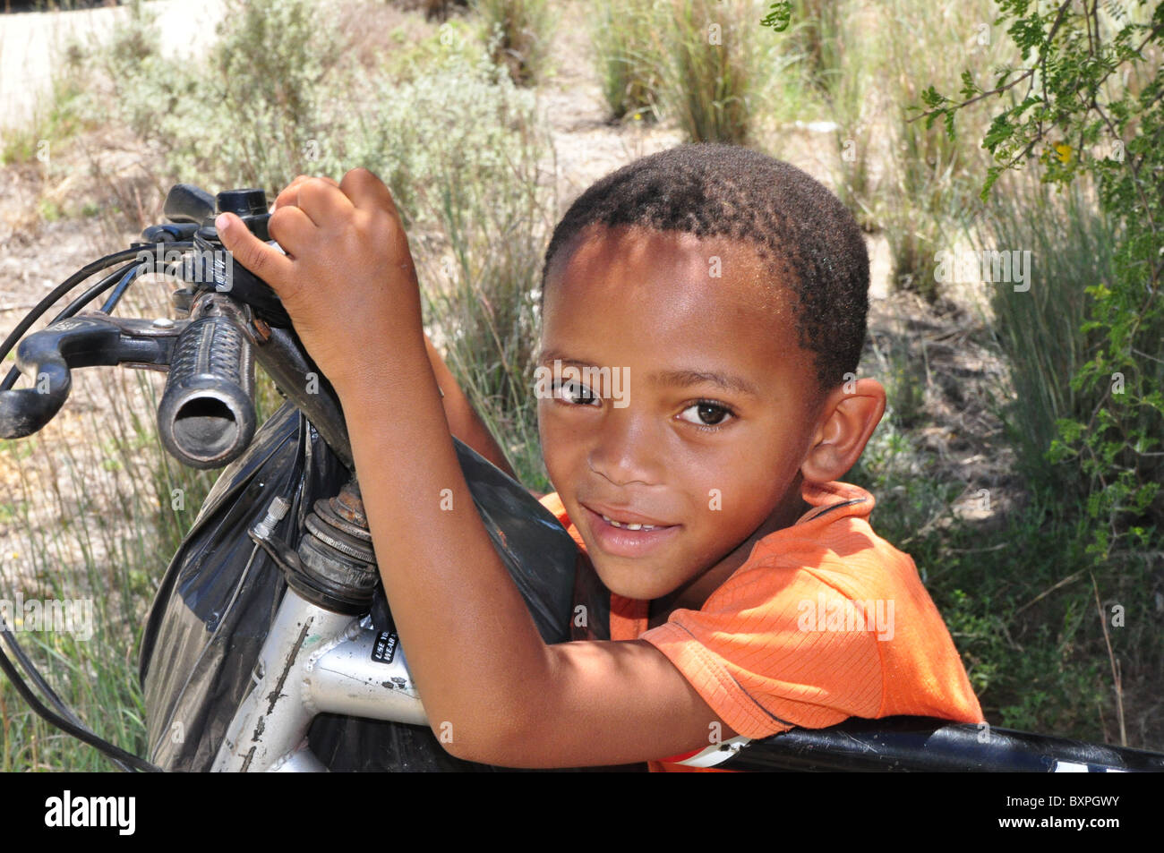 African boy with his bike smiling to the camera Stock Photo - Alamy