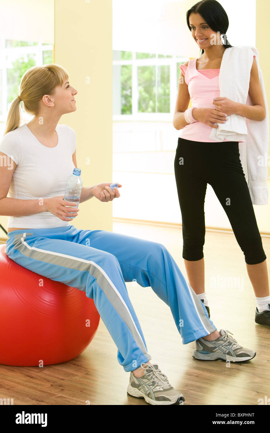 Image of two girls talking and looking at each other in the gym Stock ...