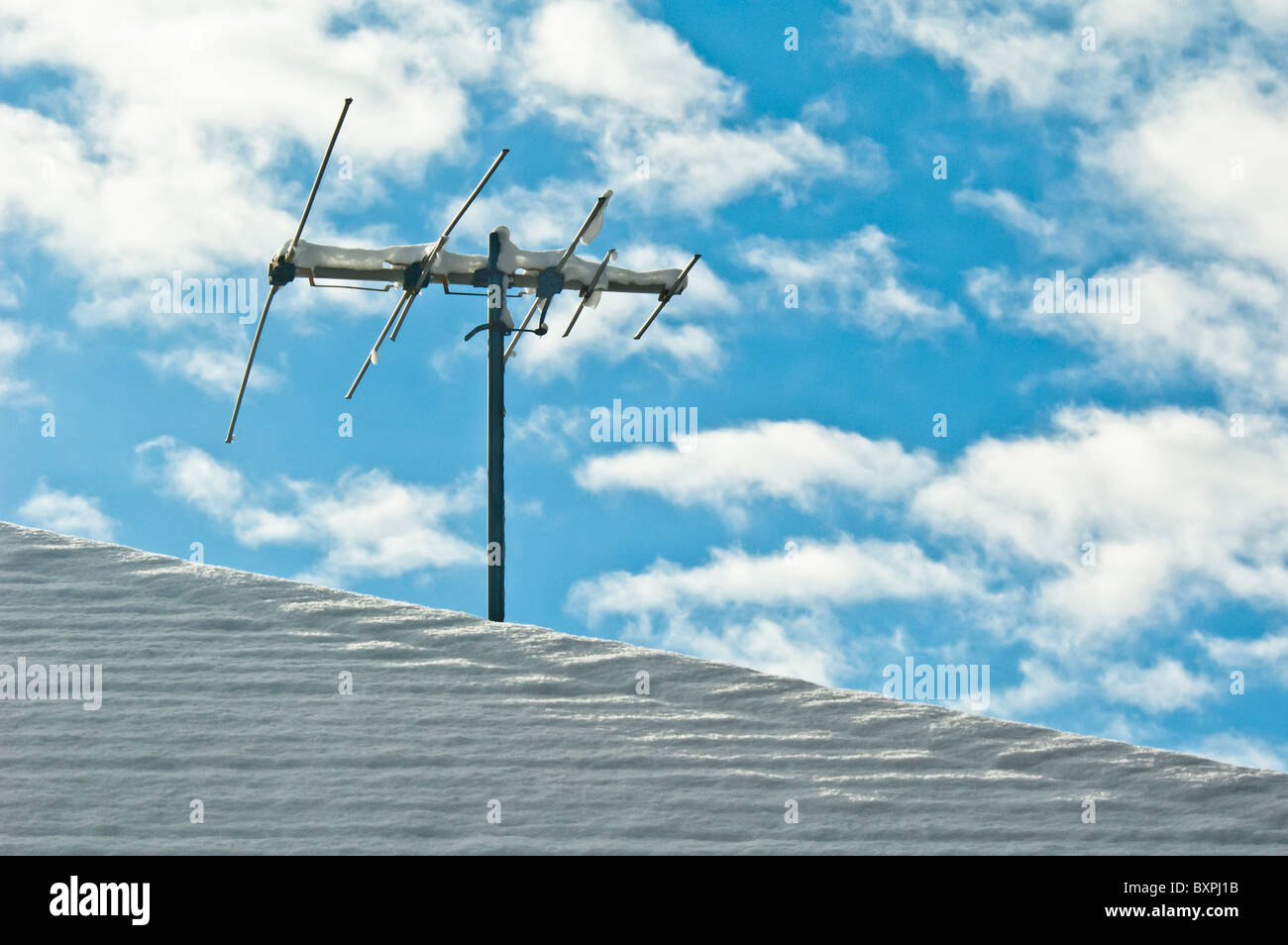 television antenna atop a snowy roof Stock Photo - Alamy