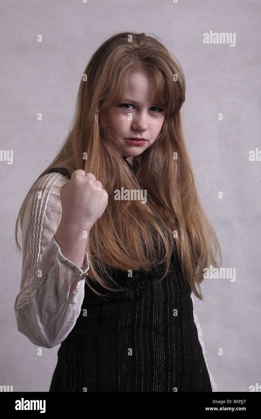 March 2008 - Teen blonde girl clenching a fist in anger Stock Photo - Alamy