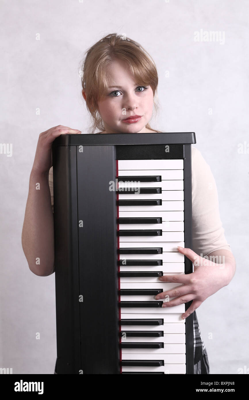 March 2008 - Young blonde musician with her keyboard Stock Photo - Alamy