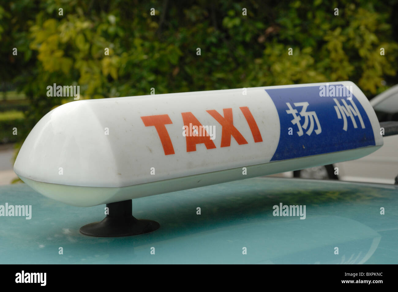 A Taxi sign on top of a taxi in China Stock Photo - Alamy