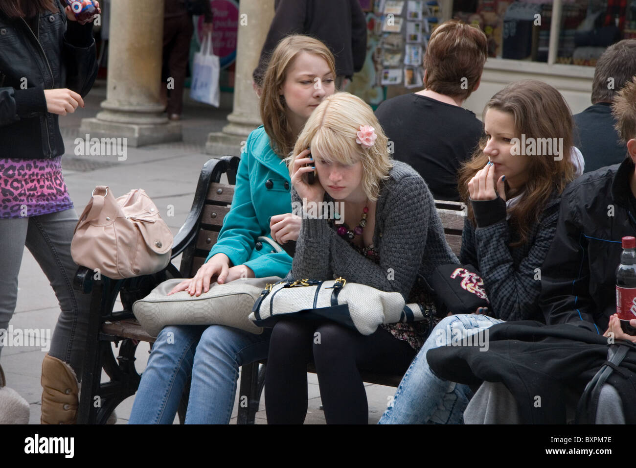 Young people on a bench Stock Photo - Alamy