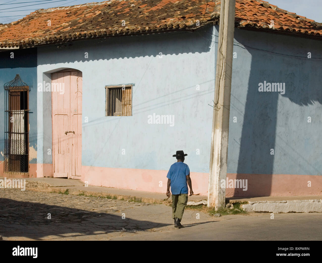 Man Walking Past Colourfully Painted Houses Stock Photo - Alamy