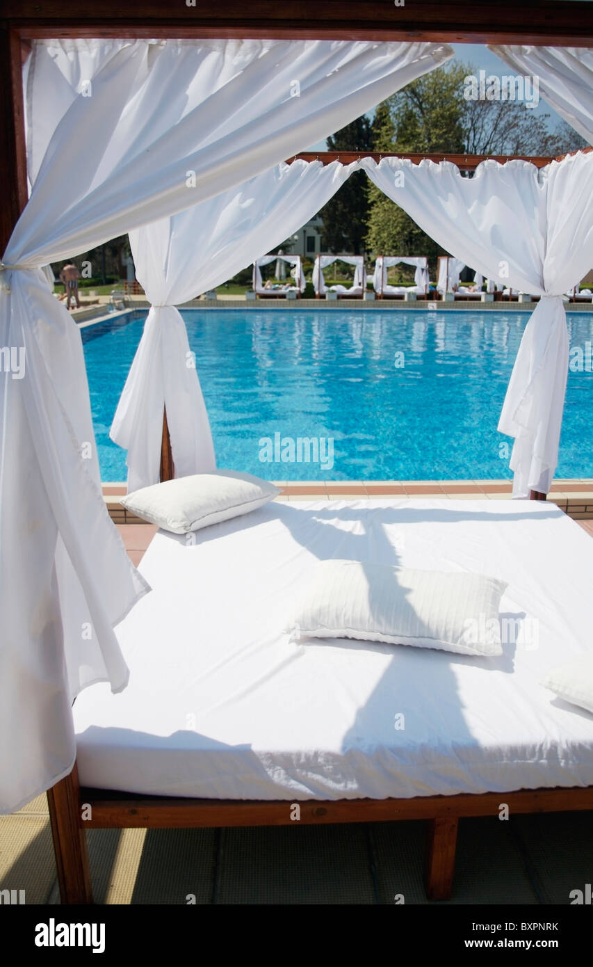 View through canopied sun bed through to swimming pool; Varna, Bulgaria ...