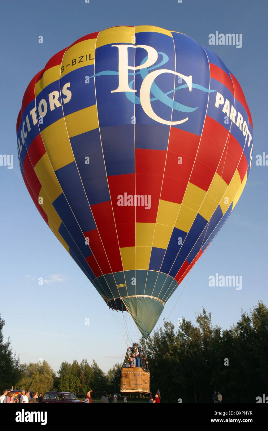 Promotional multi coloured hot air balloon rising in Buckinghamshire ...
