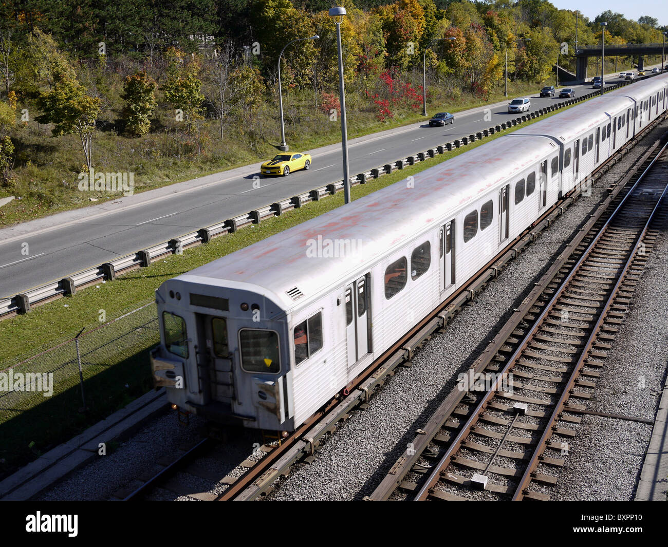Electric Commuter Train beside Freeway Stock Photo - Alamy