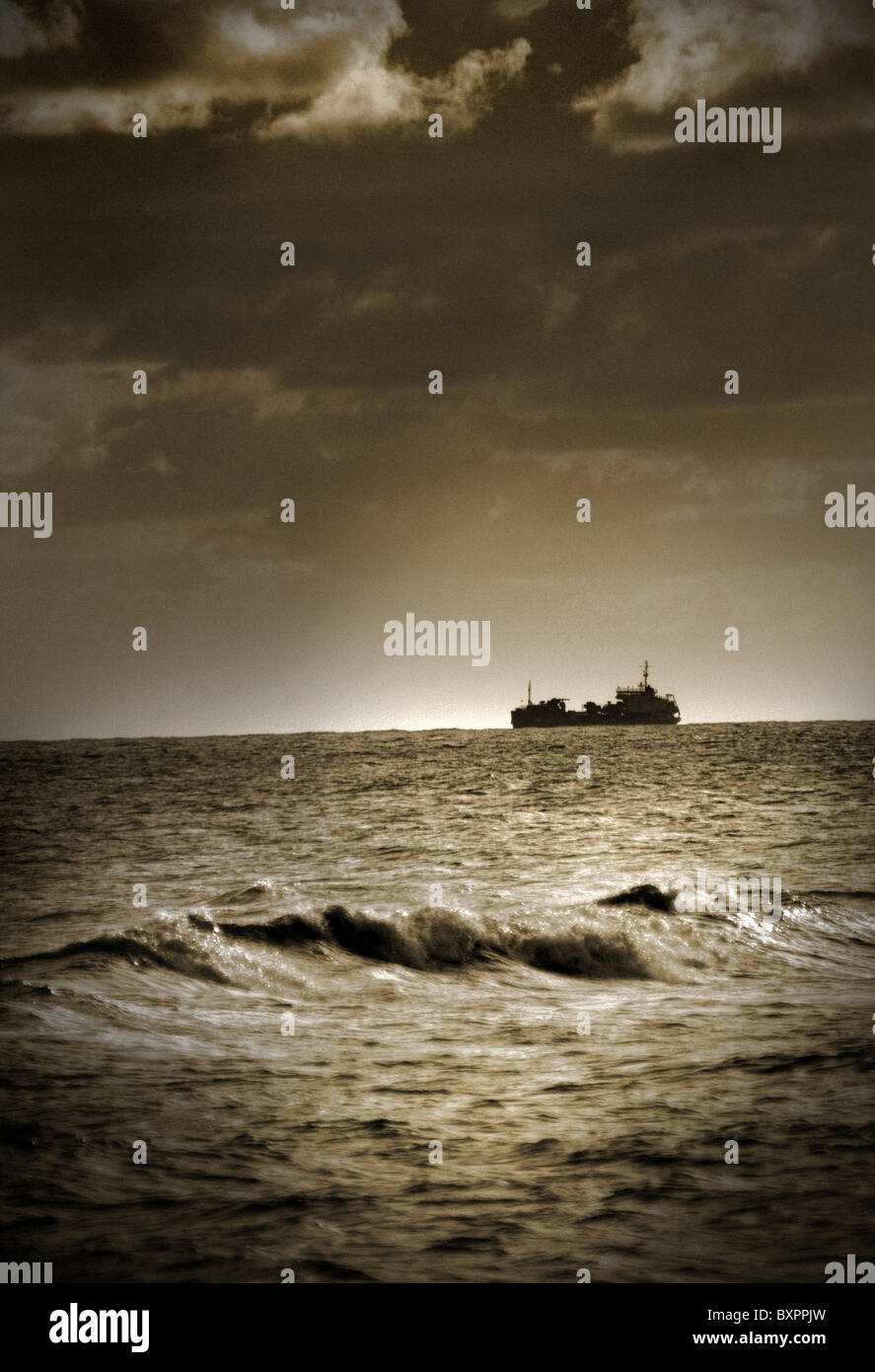 boat steaming over horizon Stock Photo - Alamy