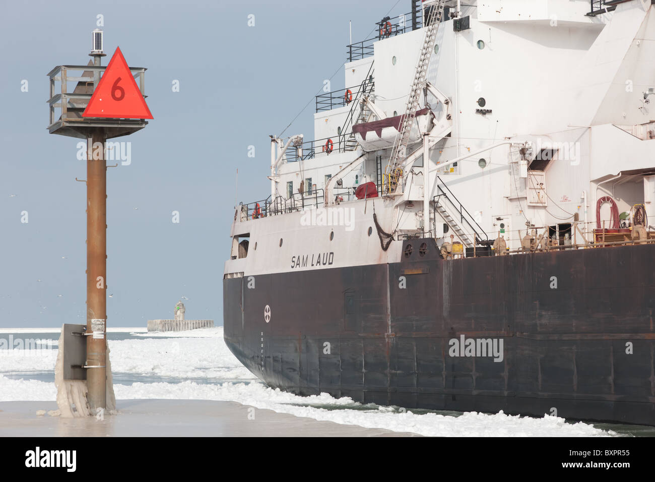 Cargo ship M/V Sam Laud passes a channel marker entering partially ...