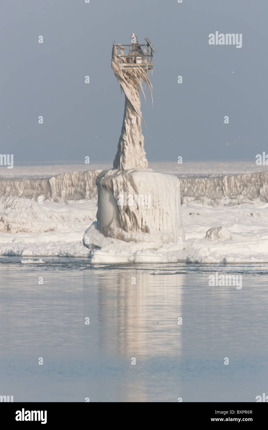 A channel marker in Cleveland Harbor covered by frozen layers of ice ...