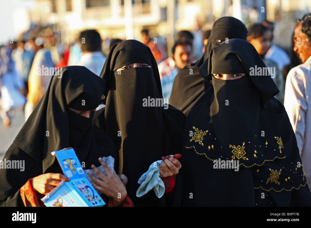 Group of Muslim women in hijab opening present, Haji Ali, Mumbai, India ...