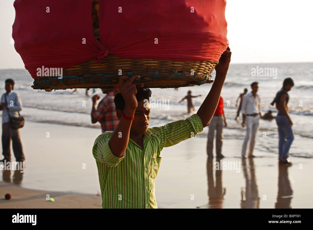 Indian Trader carrying load on Juhu beach, Mumbai, India Stock Photo ...