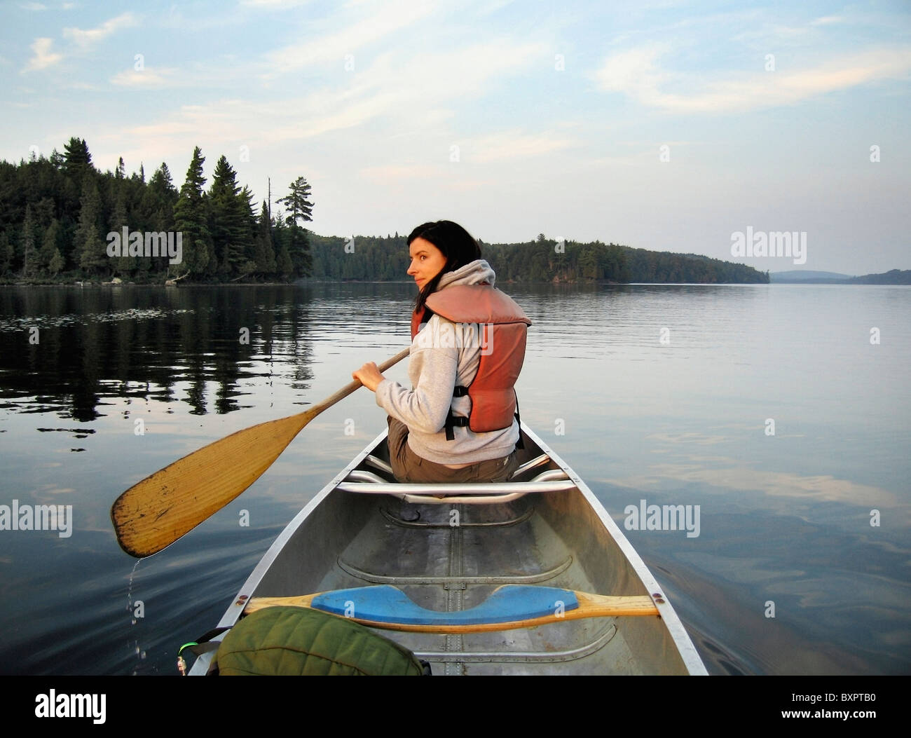 Woman Canoeing On A Lake Stock Photo - Alamy