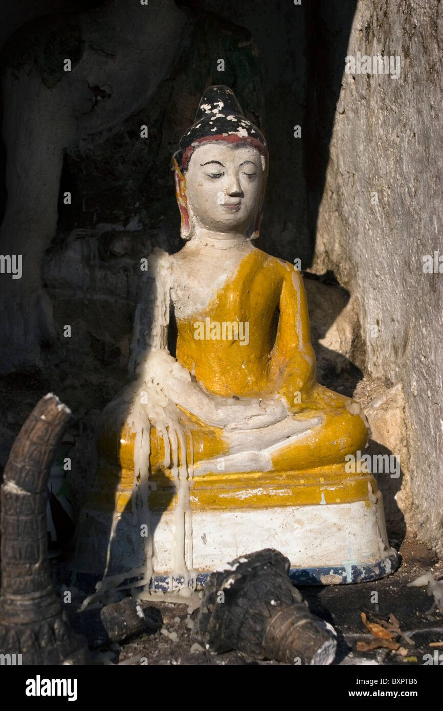 A beautiful small Buddhist statue is on display in a stupa at a temple ...