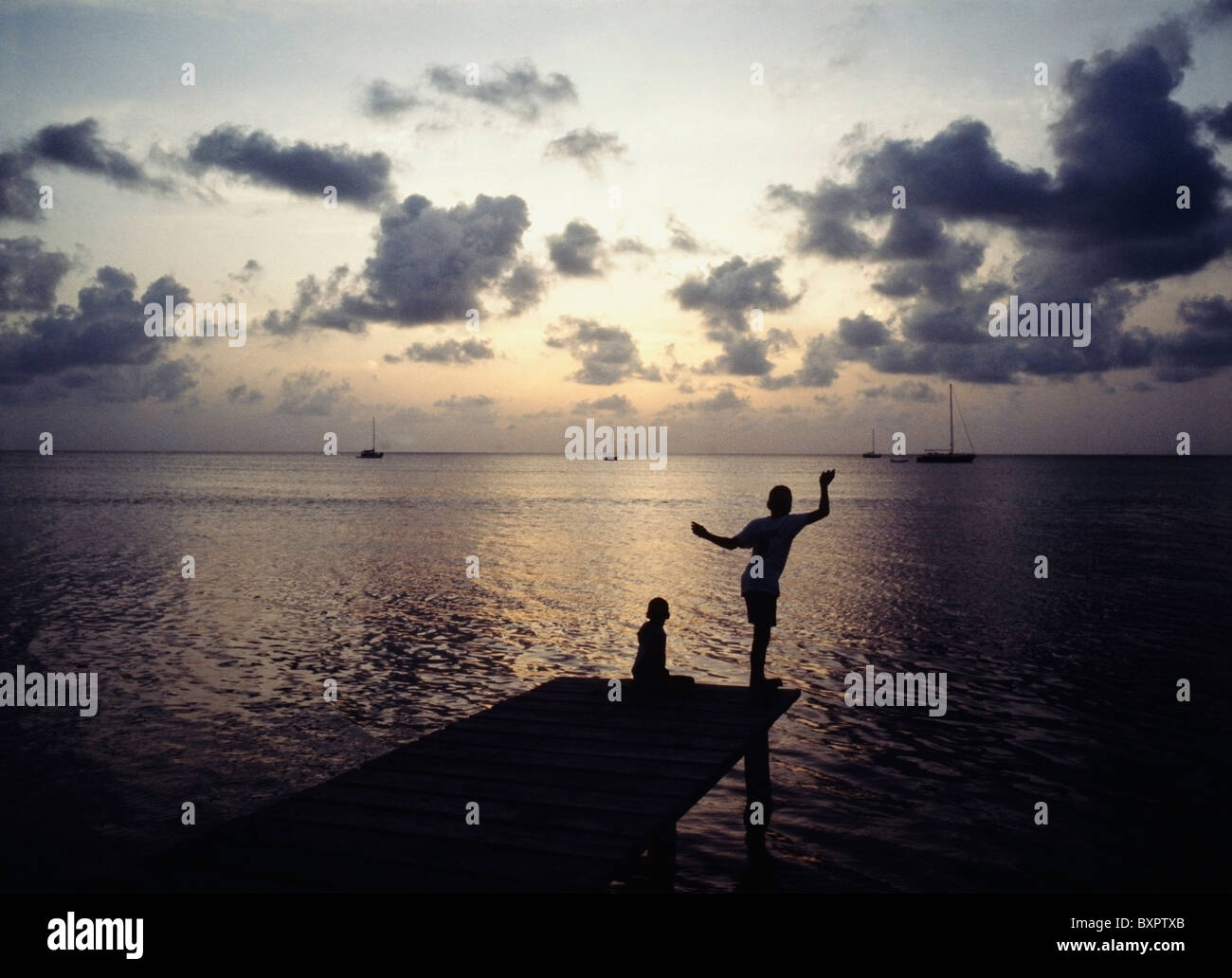 Two Young Boys Fishing Off A Pier Stock Photo - Alamy