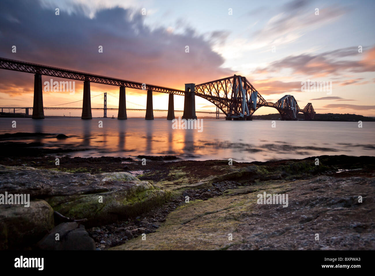 Forth Bridge and Road Bridge at Sunset Stock Photo - Alamy