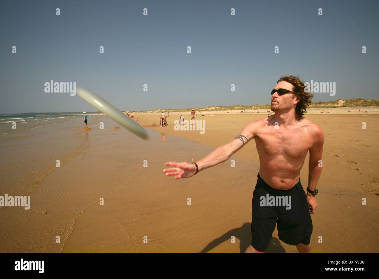 Man Playing Frisbee On The Beach Stock Photo - Alamy