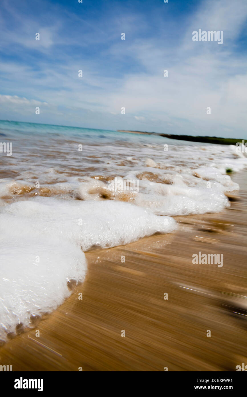 Sea Washing In Onto Sandy Beach Stock Photo - Alamy