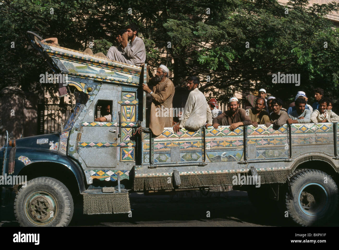 A group of Pakistani male laborers are transported to a work site in ...