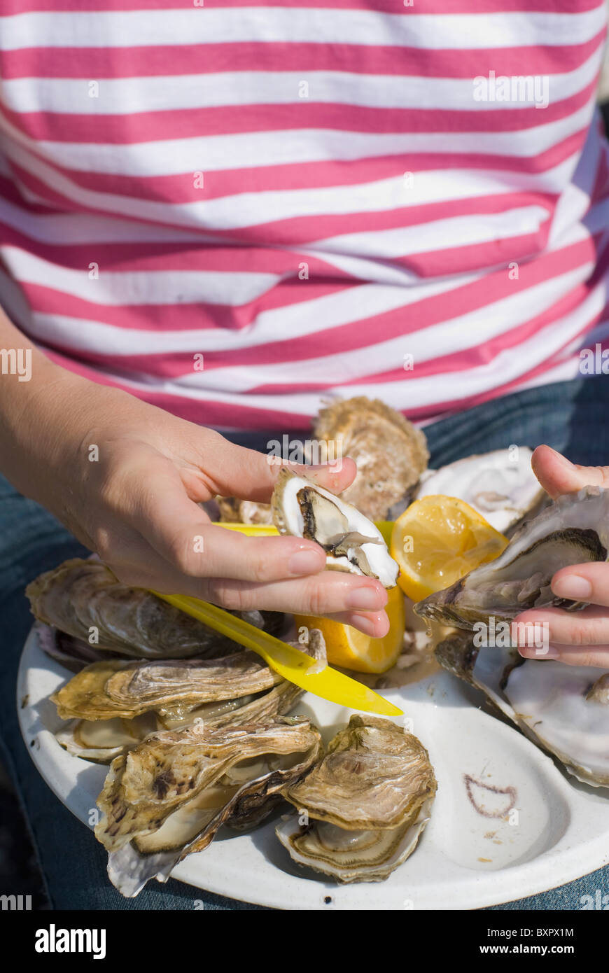 Woman opening oysters hi-res stock photography and images - Alamy