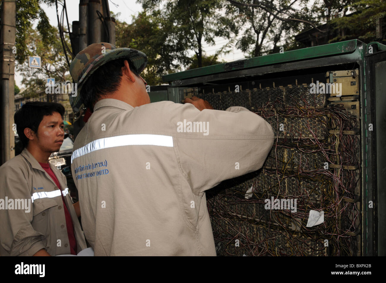 Two Workers repair a Switch Box in Bangkok Stock Photo - Alamy
