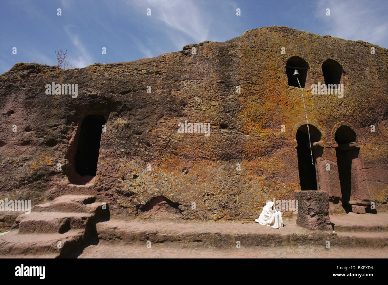 Priest Sitting Outside Rock Church Stock Photo - Alamy