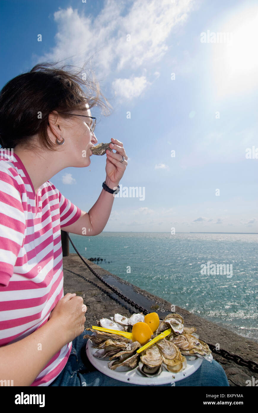 Woman Eating Oysters Beside The Sea In Cancale Stock Photo - Alamy