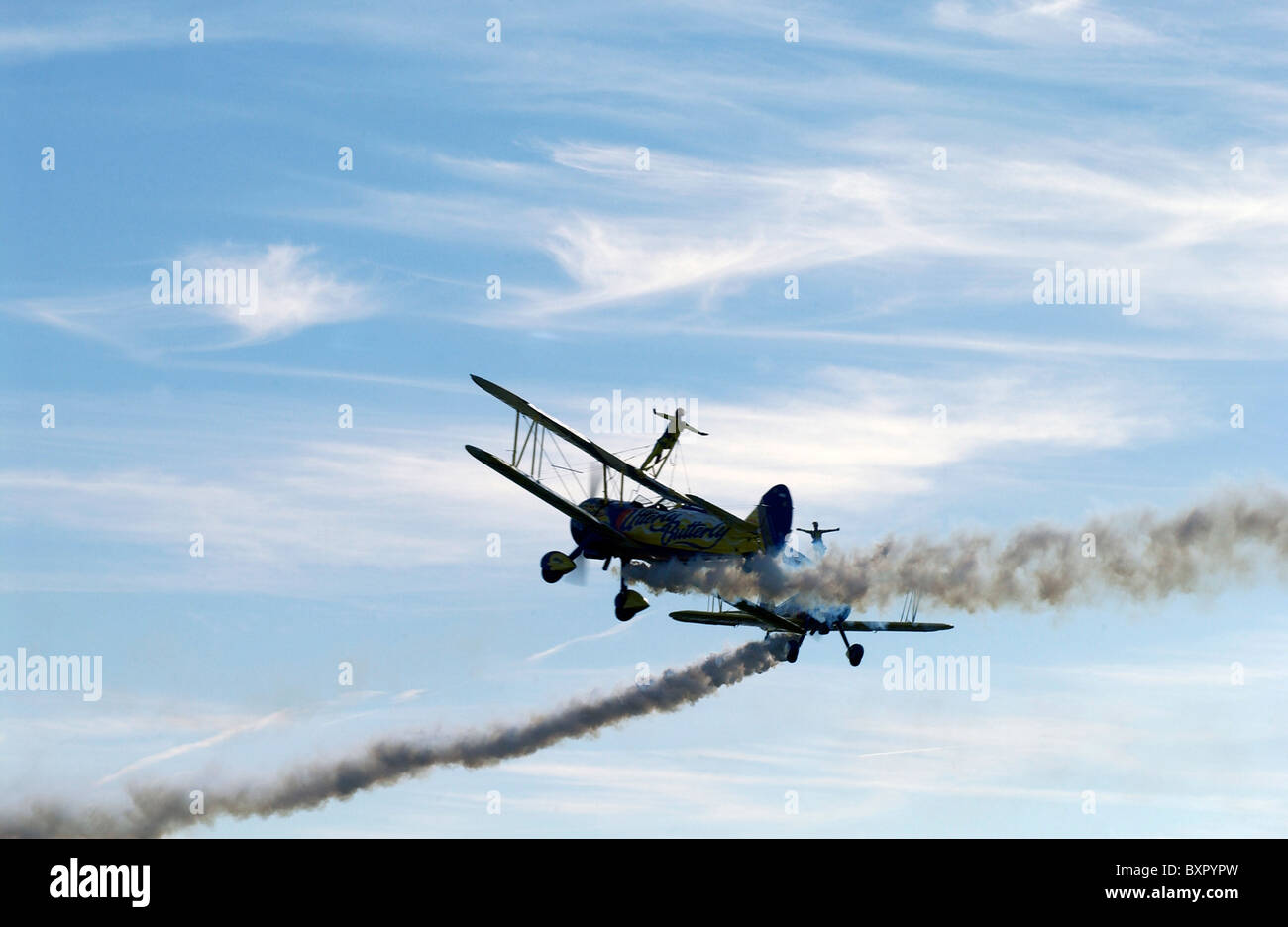 Two stunt biplanes with two wing-walking stunt performers (both girls ...