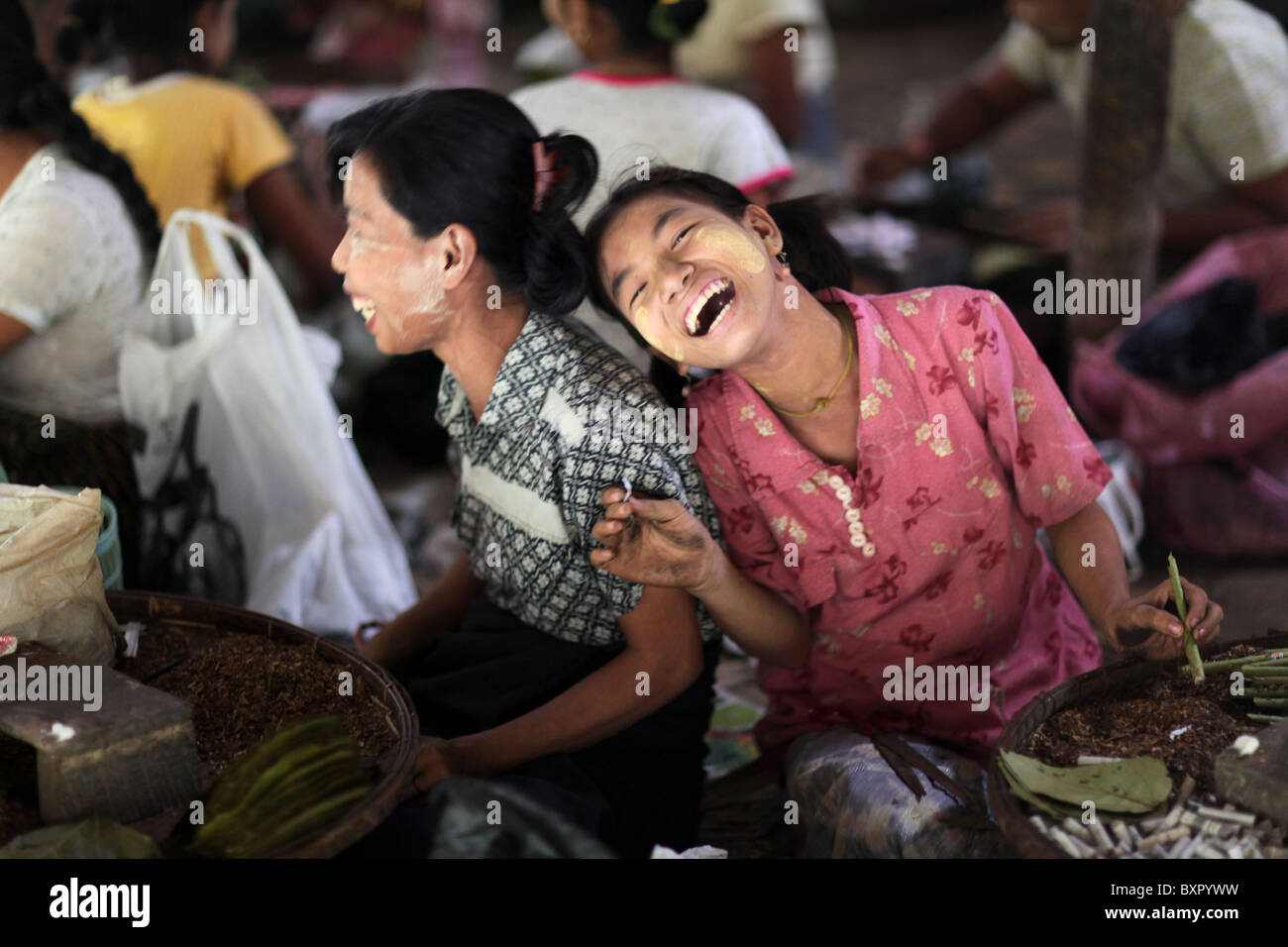 Women and children working at a village cheroot or cigar factory in ...