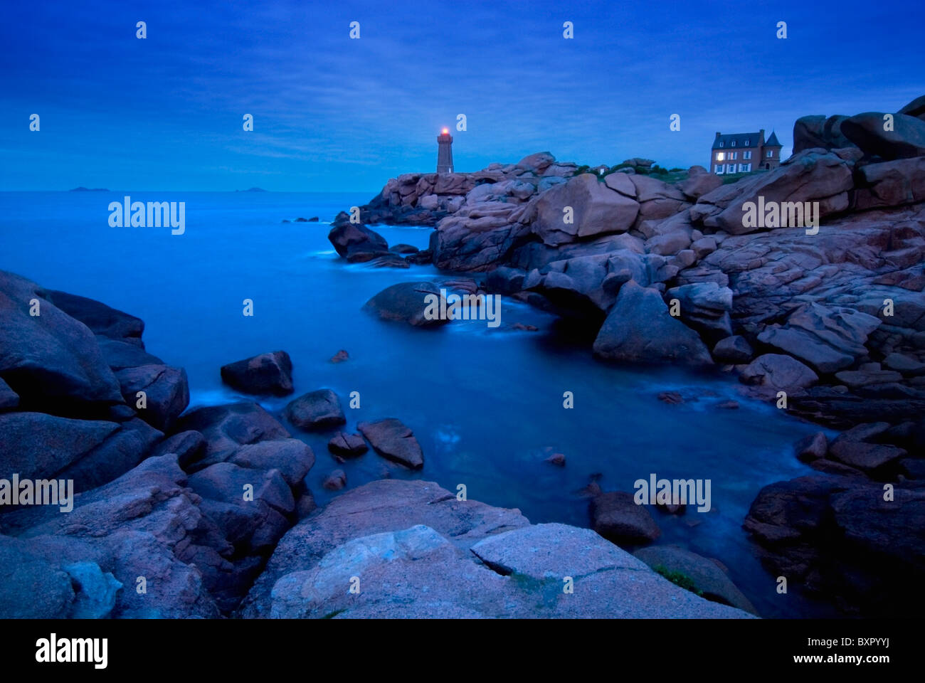 Small Lighthouse And House At Dusk Stock Photo - Alamy