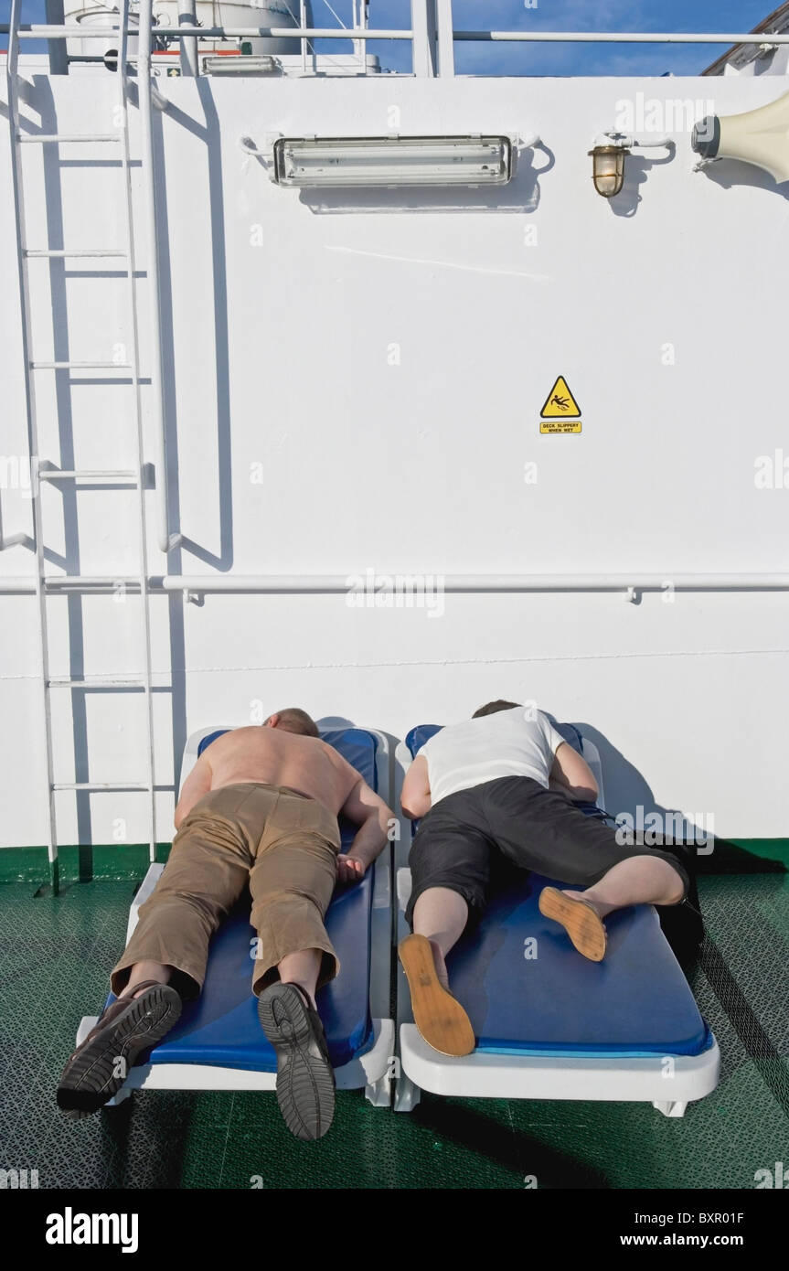 Cruise Ship Passengers Onboard Ship Sleeping On The Deck Stock Photo ...
